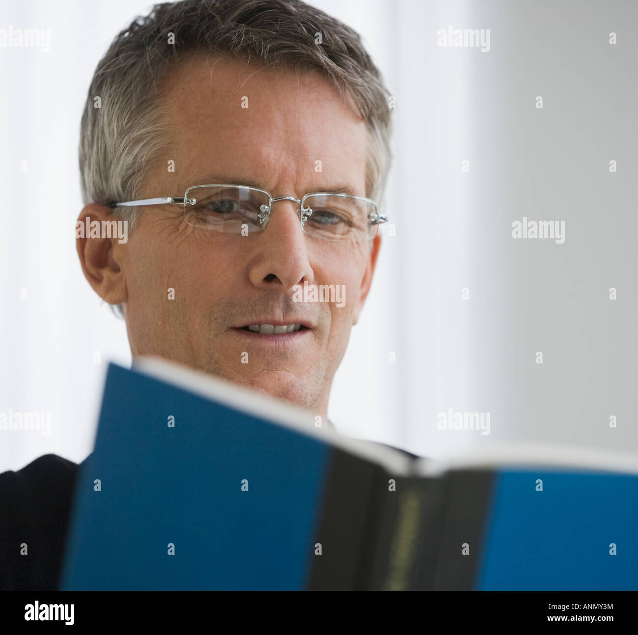 Man reading book Stock Photo - Alamy