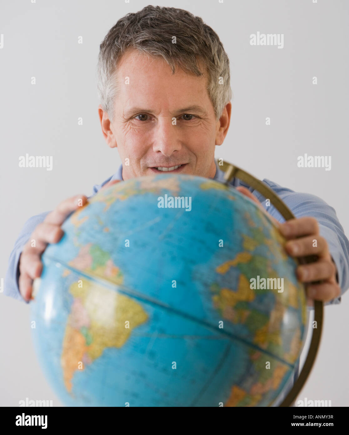 Man holding globe Stock Photo - Alamy