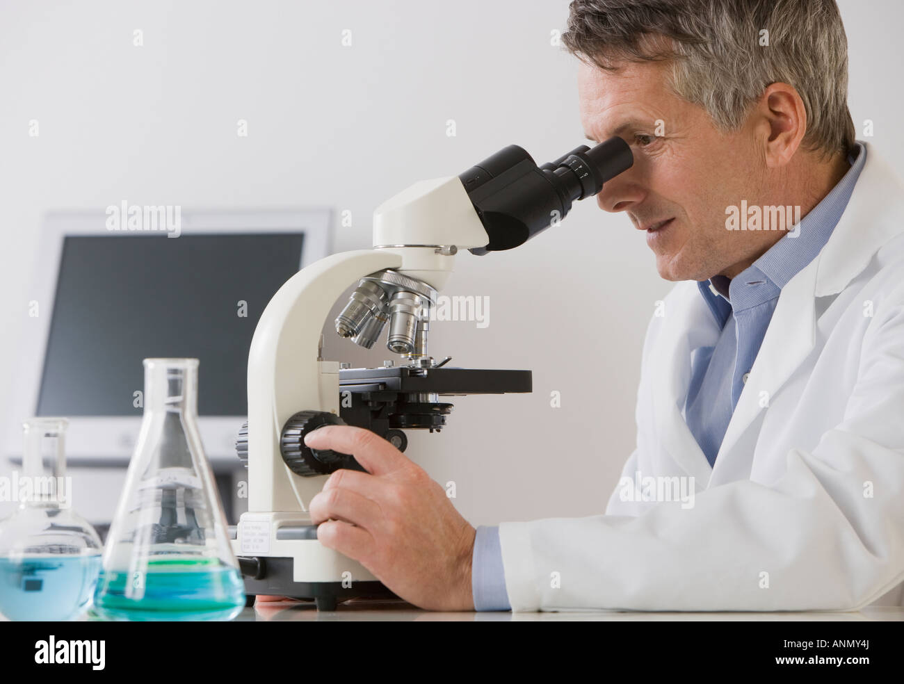 Male scientist looking in microscope Stock Photo - Alamy