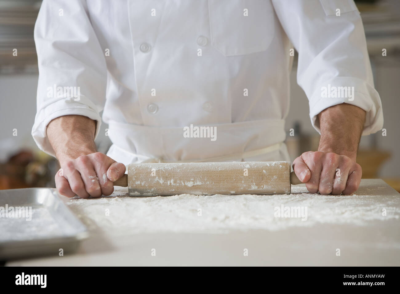 Pastry chef rolling out dough Stock Photo - Alamy