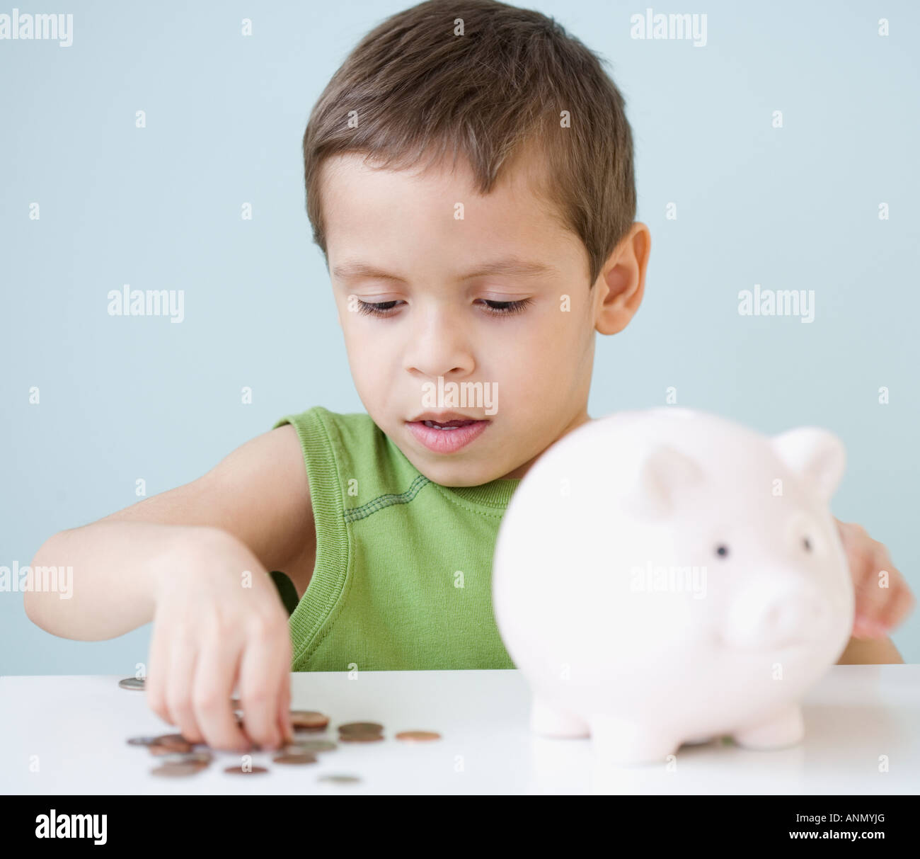 Boy counting coins from piggy bank Stock Photo - Alamy