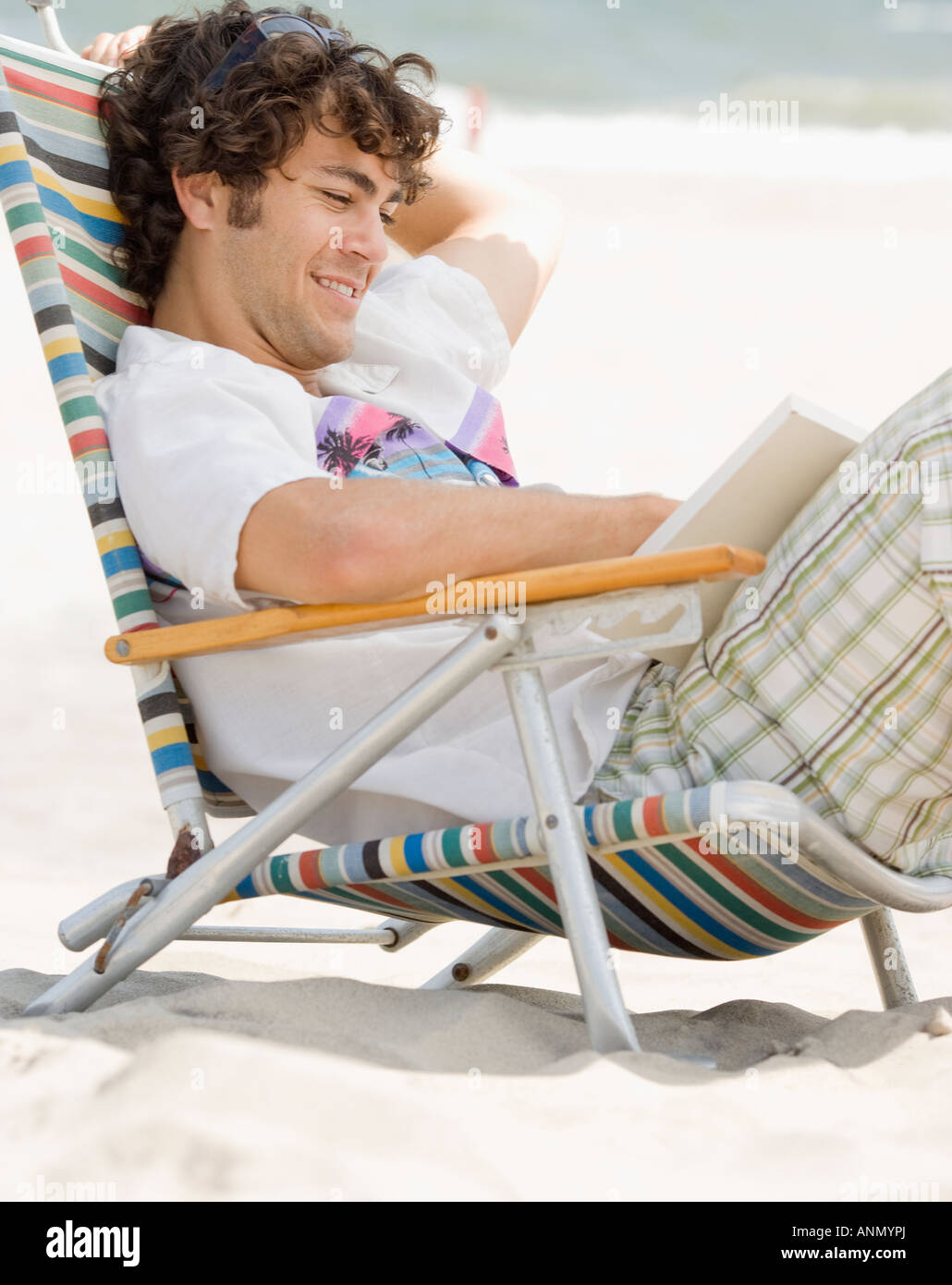 Man reading at beach Stock Photo - Alamy