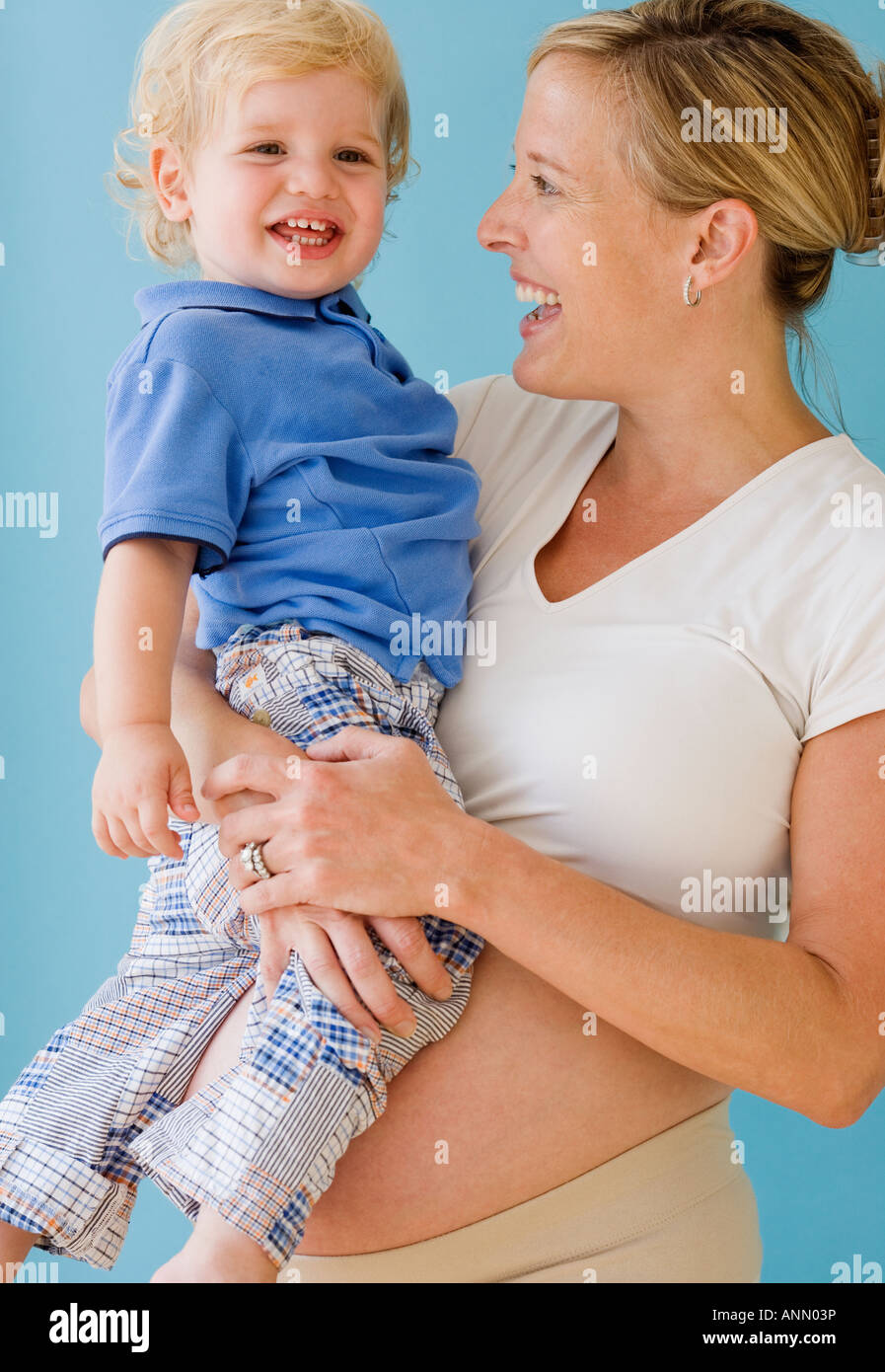Pregnant mother hugging child Stock Photo - Alamy