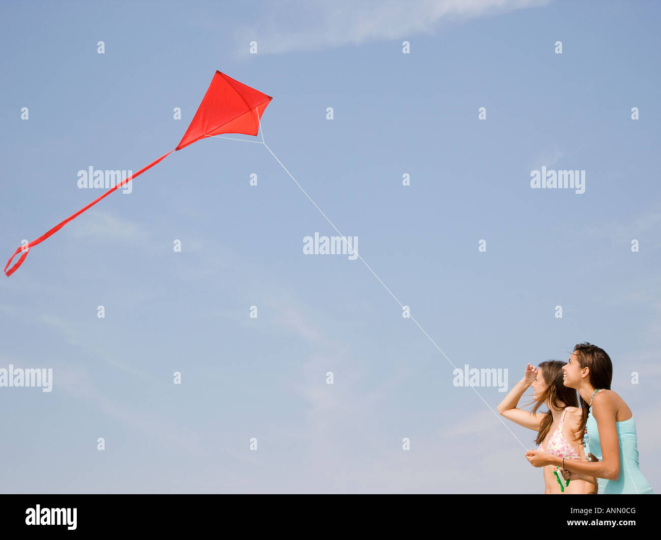 Young women flying kite Stock Photo - Alamy