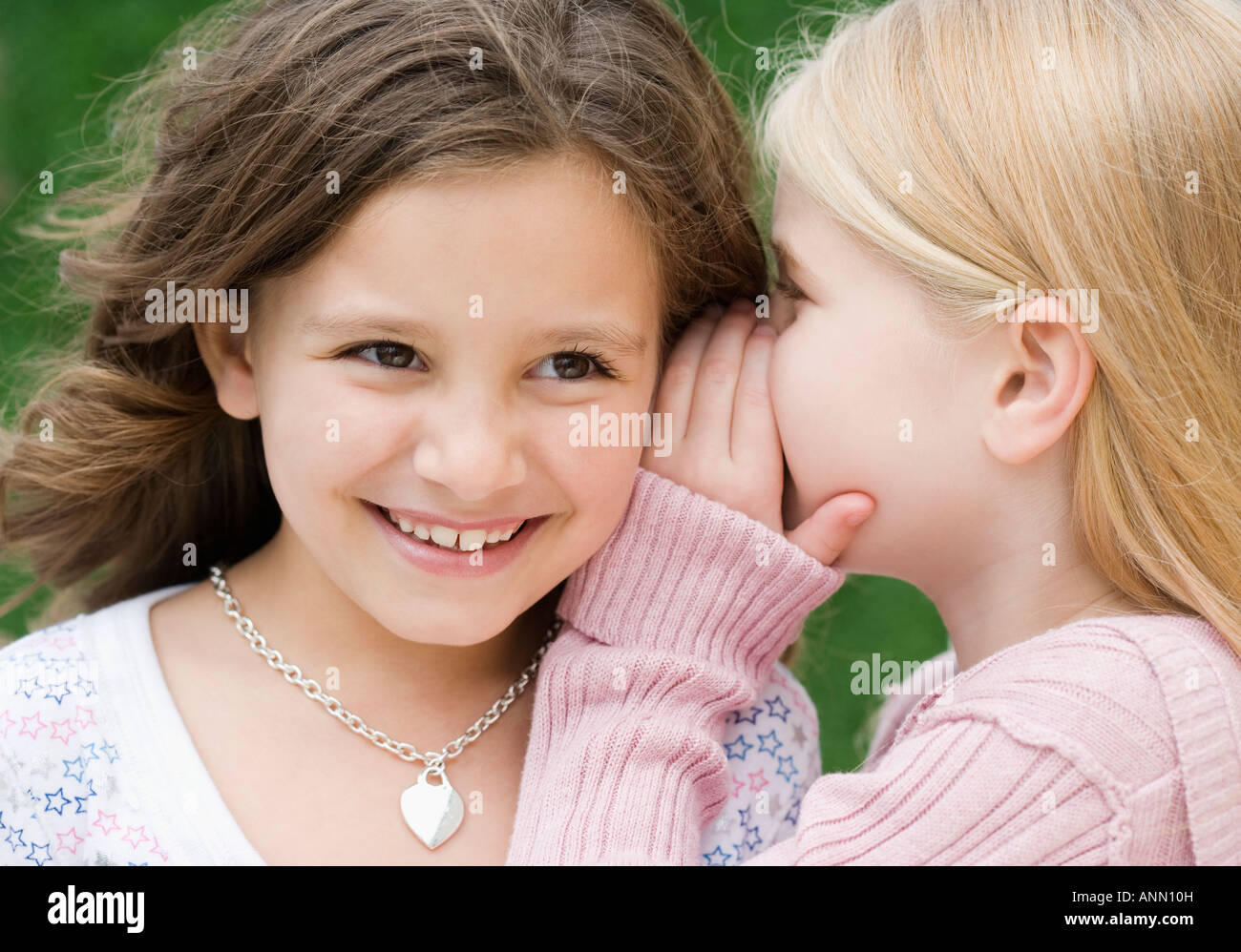 Girl telling secret Stock Photo - Alamy