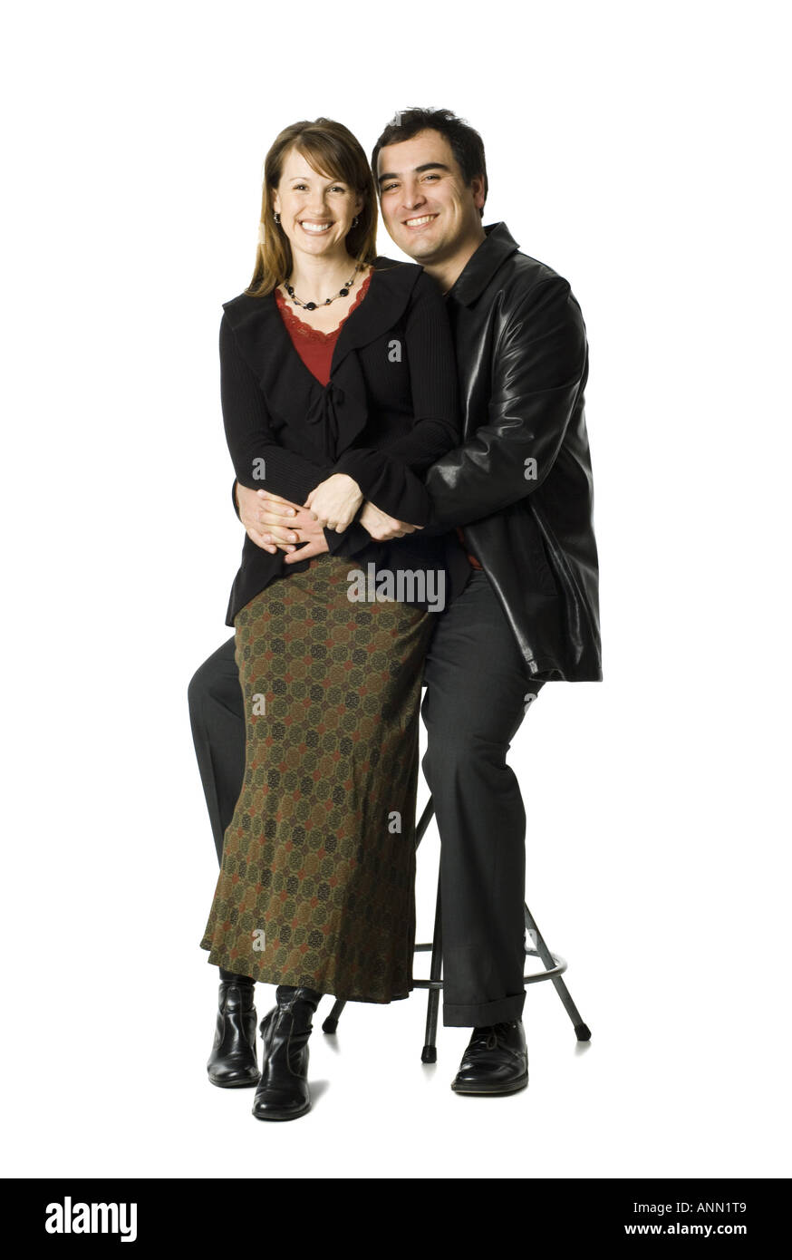 Adult couple embracing on a chair Stock Photo - Alamy