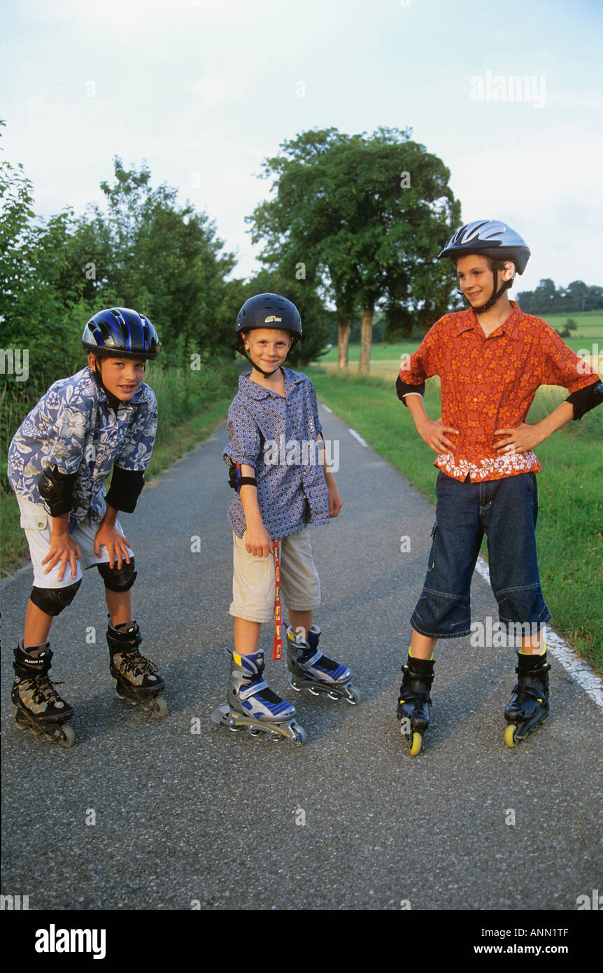 three boys with Skates Stock Photo - Alamy