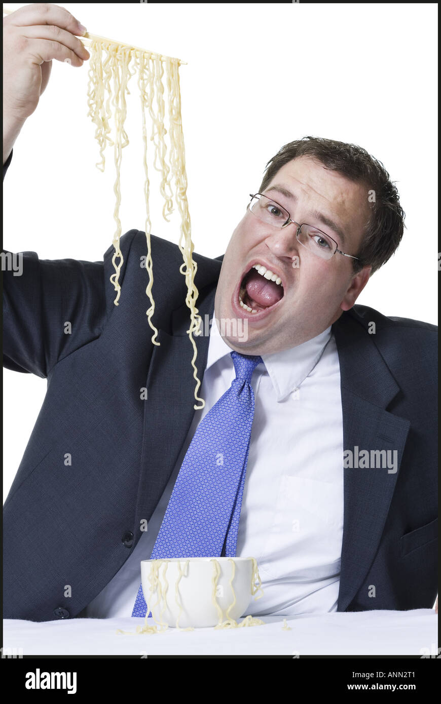 Portrait of a young man eating noodles Stock Photo - Alamy