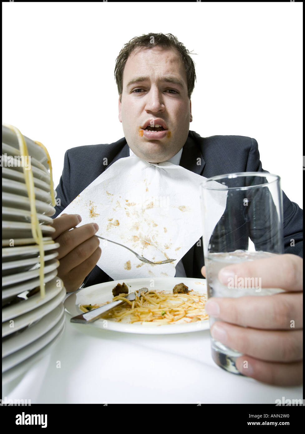Portrait of a young man overeating at the dining table Stock Photo - Alamy