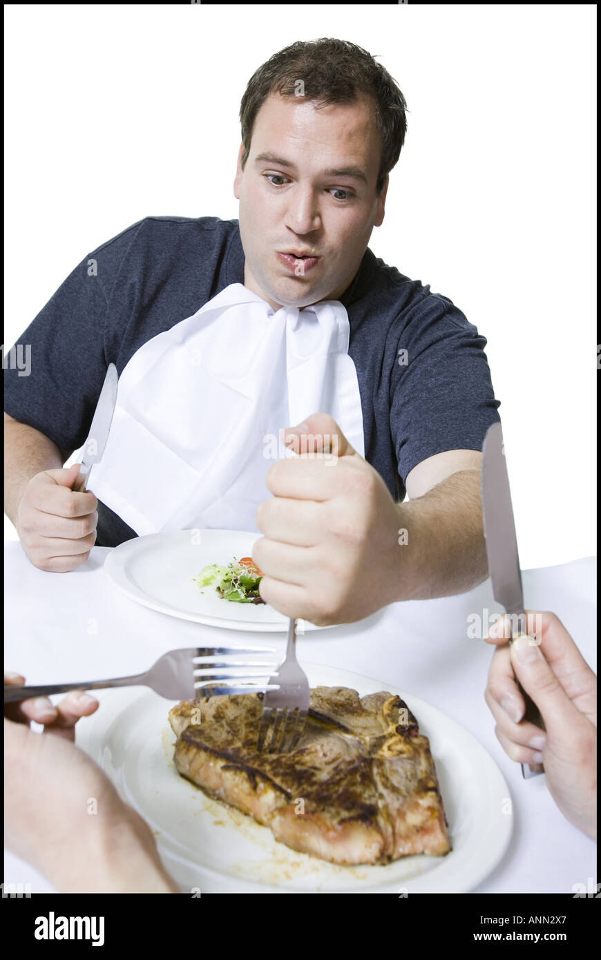Close up of a young man taking food from another person s plate Stock ...