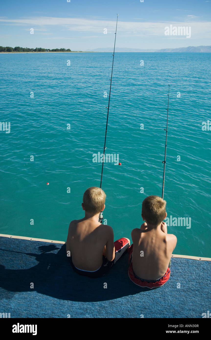 Brothers fishing off dock in lake, Utah, United States Stock Photo - Alamy