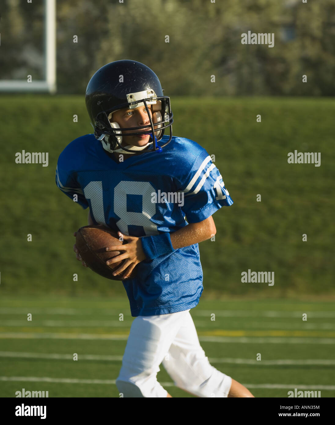 Young football player running with ball Stock Photo - Alamy