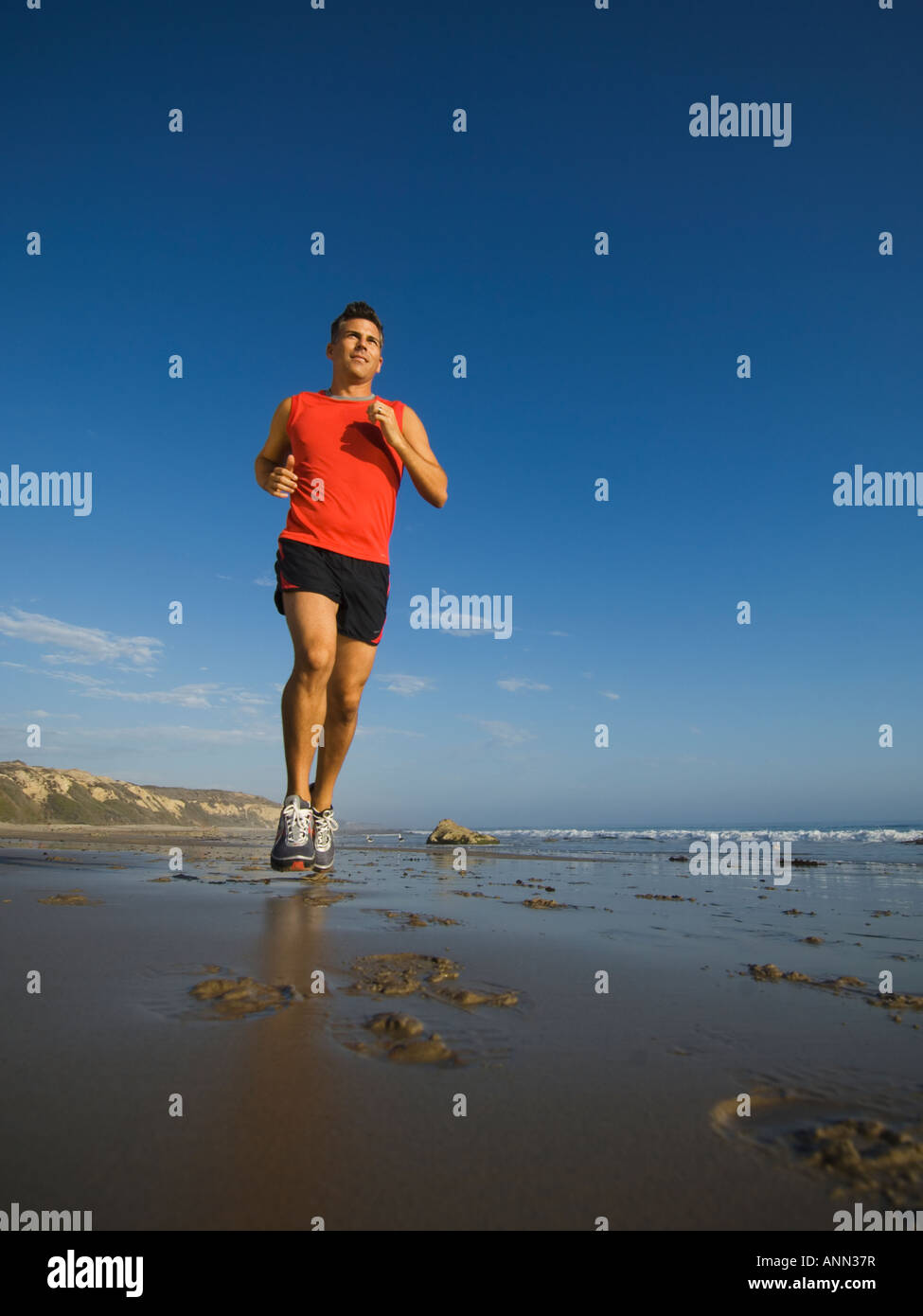 Man jogging on beach Stock Photo - Alamy