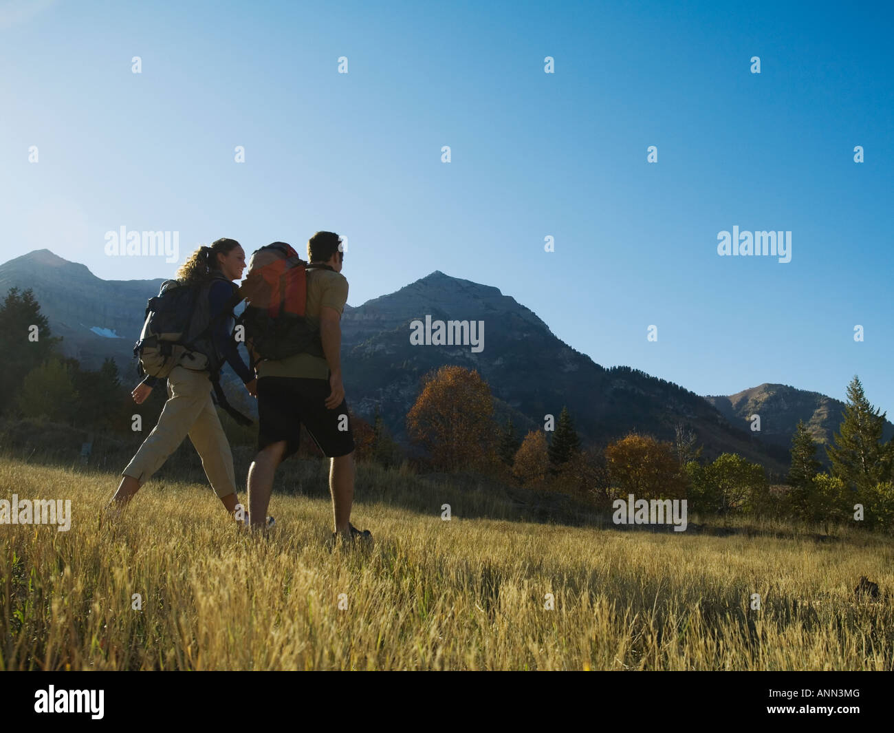Couple hiking with backpacks, Utah, United States Stock Photo - Alamy
