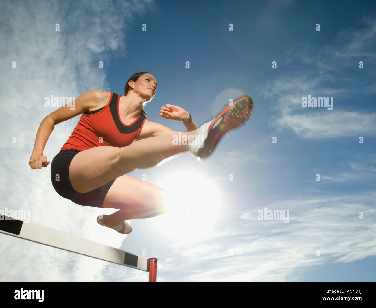 Female athlete jumping hurdle, Utah, United States Stock Photo - Alamy
