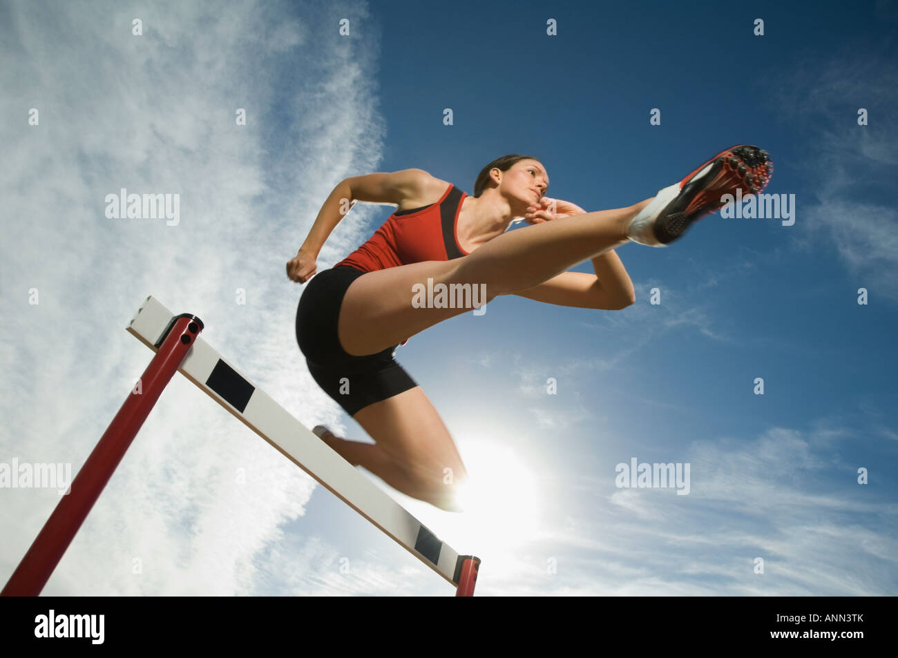 Female athlete jumping hurdle, Utah, United States Stock Photo - Alamy