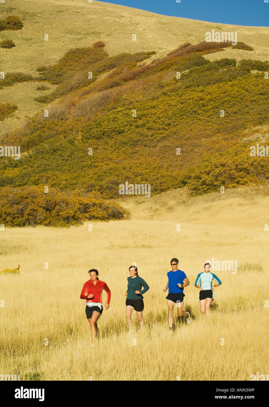 Group of people running in field, Salt Flats, Utah, United States Stock ...