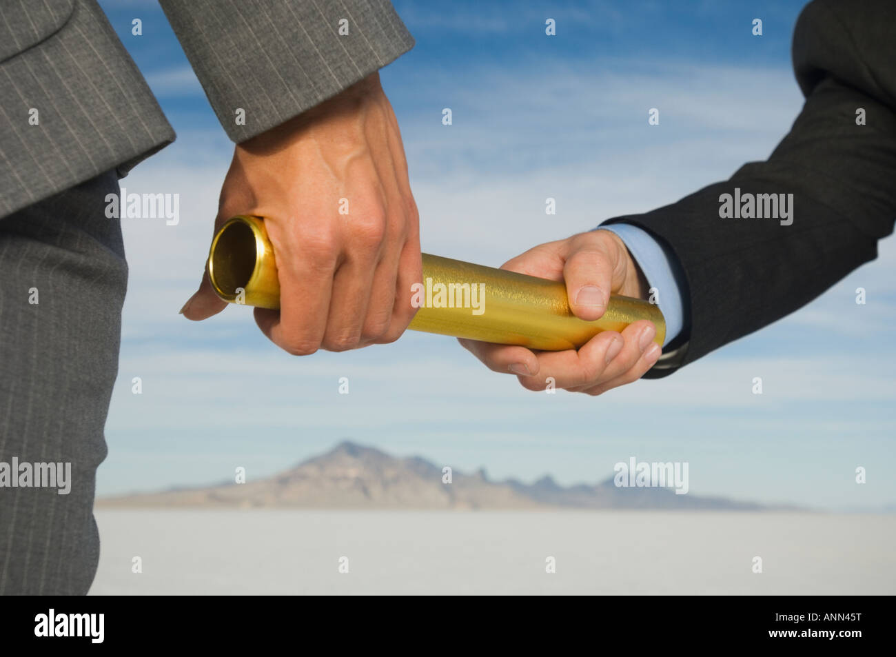Businesspeople handing off baton in relay race, Salt Flats, Utah ...