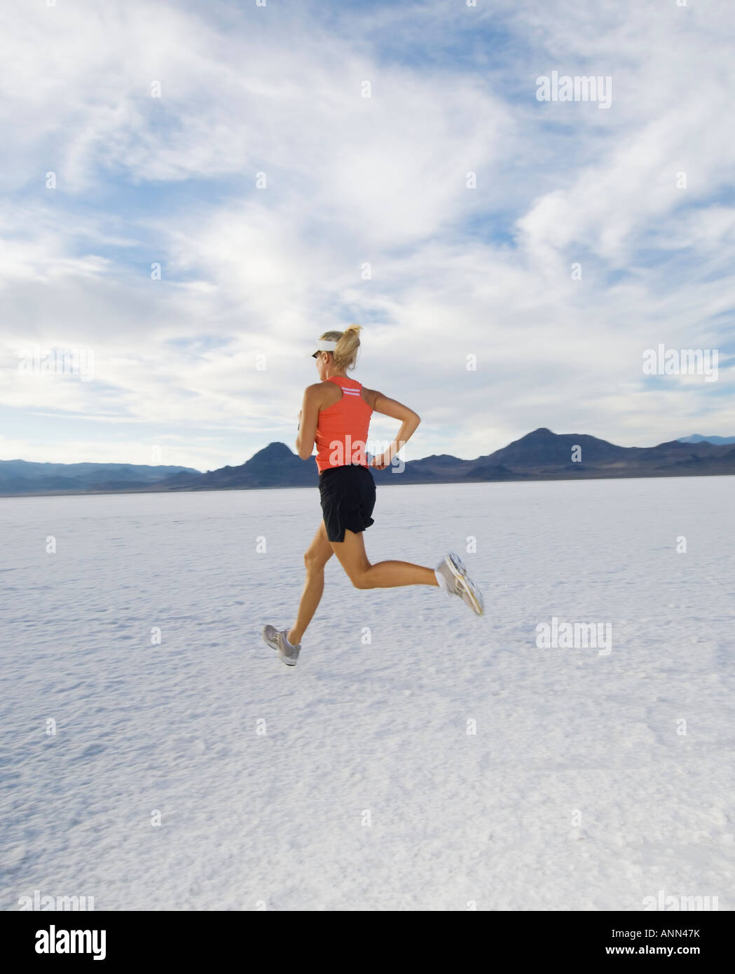 Woman running on salt flats, Utah, United States Stock Photo - Alamy