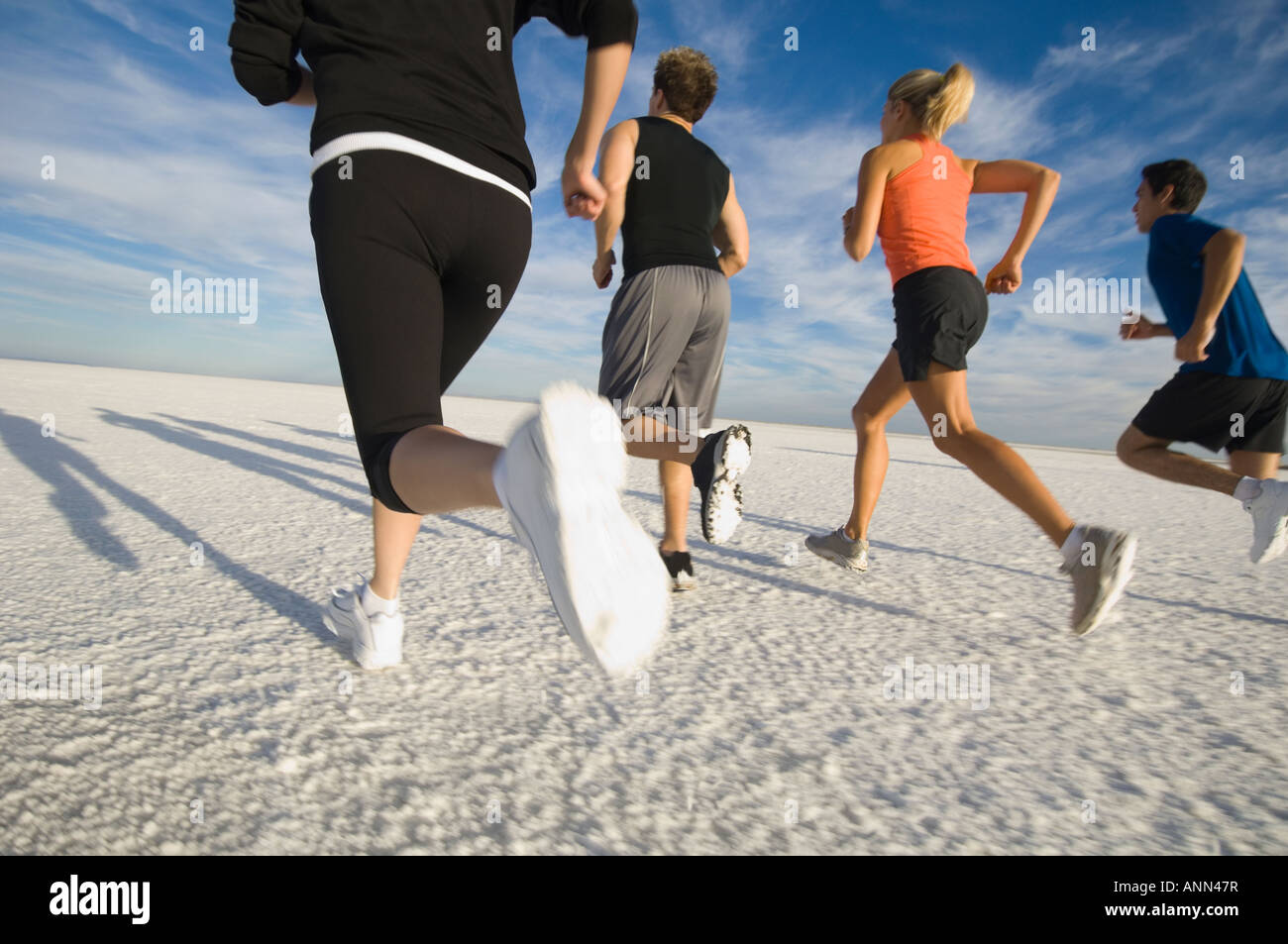 Group of people running on salt flats, Utah, United States Stock Photo ...