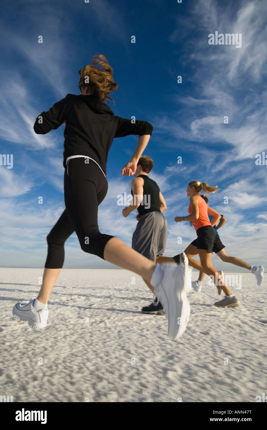 Group of people running on salt flats, Utah, United States Stock Photo ...
