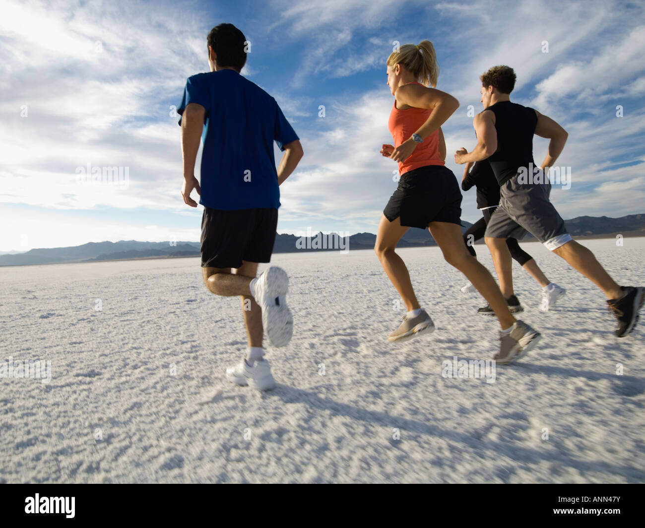 Group of people running on salt flats, Utah, United States Stock Photo ...