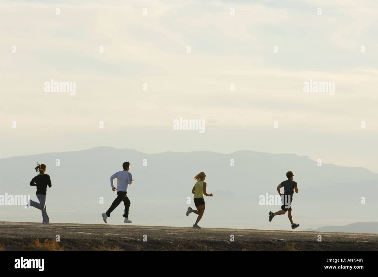 Group of people running on road, Utah, United States Stock Photo - Alamy