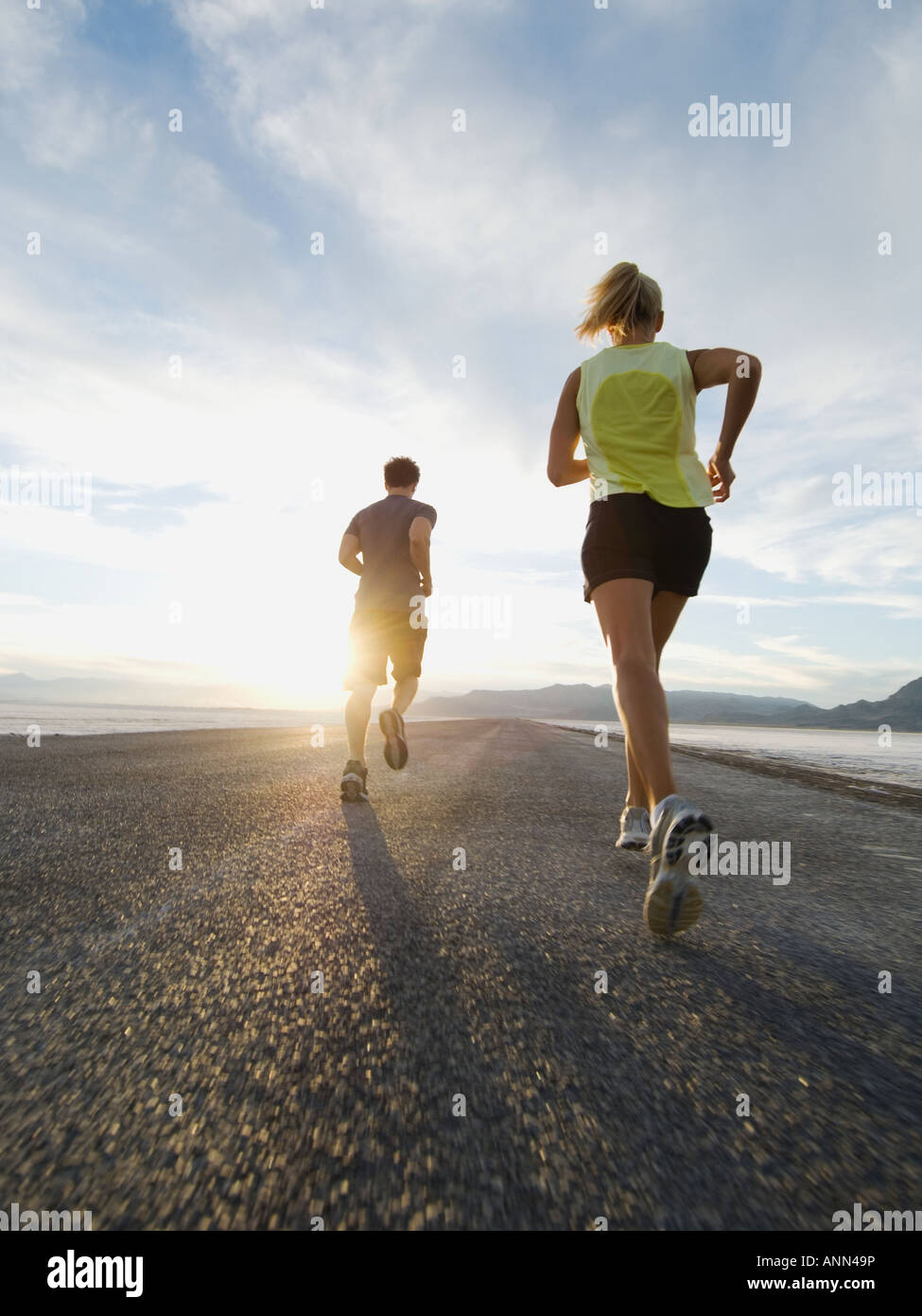 Couple running on road, Utah, United States Stock Photo - Alamy