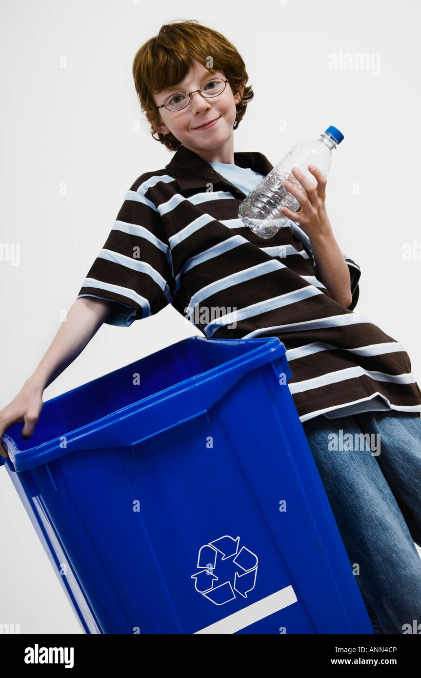 Boy leaning on recycling bin Stock Photo - Alamy