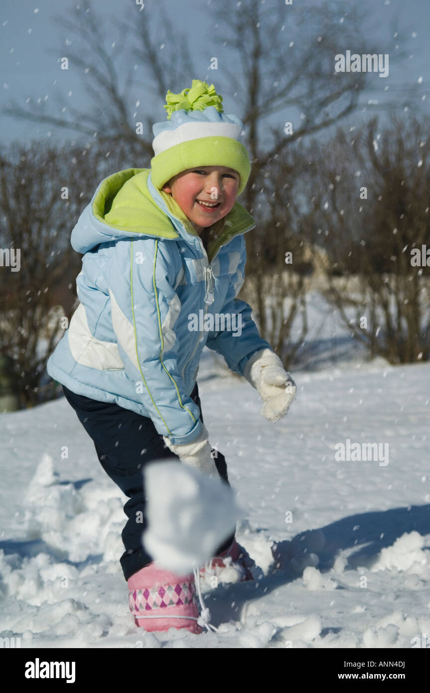 Girl throwing snowball Stock Photo - Alamy