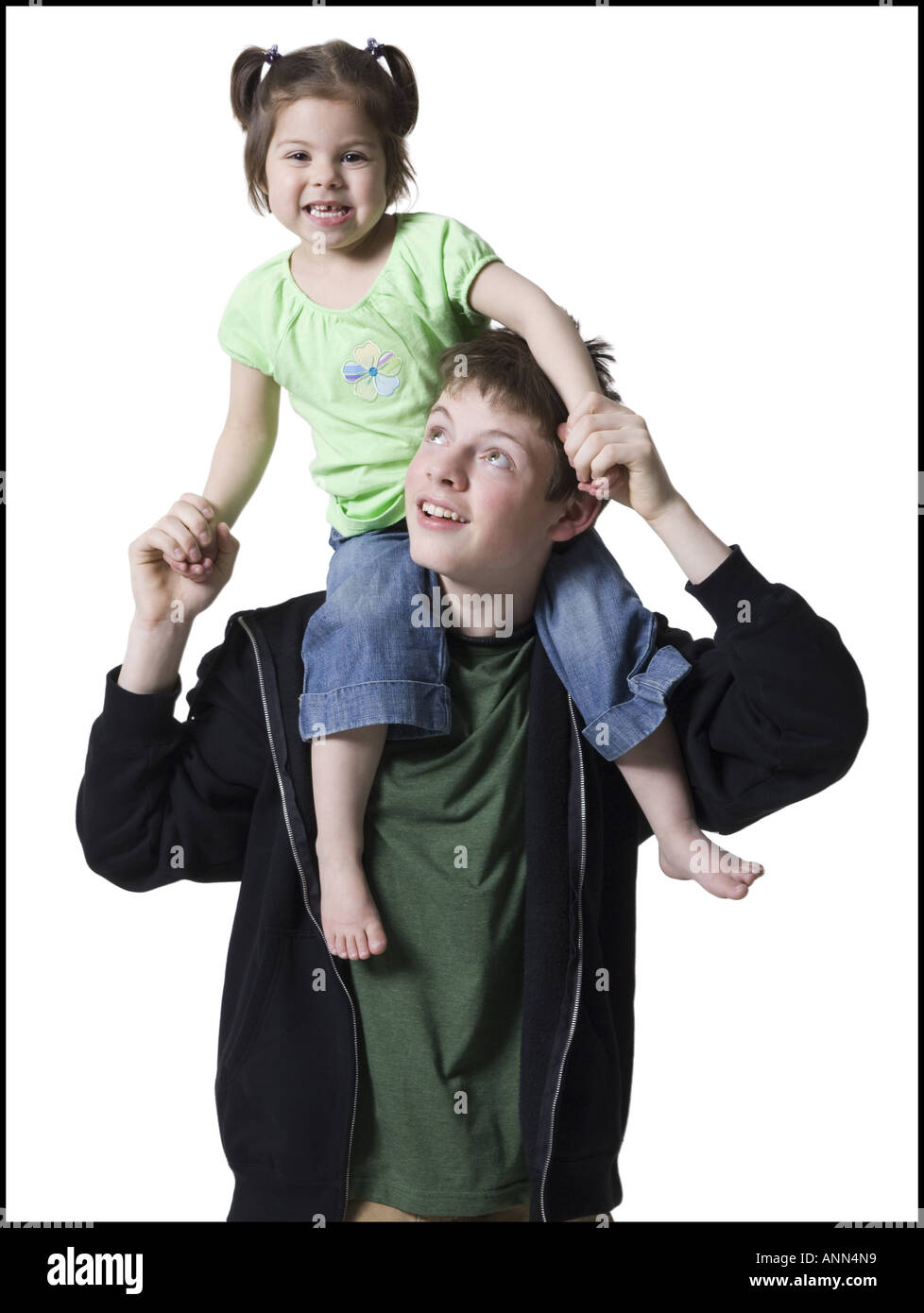 Close up of a brother carrying his sister on his shoulders Stock Photo ...