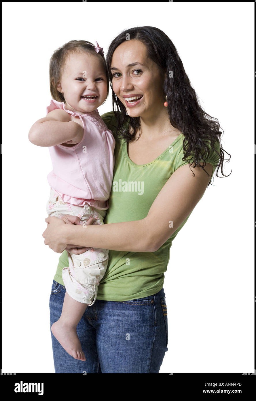 Portrait of a young woman carrying her daughter Stock Photo - Alamy