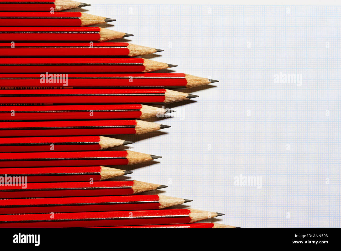 Pencils forming bar graph pattern on graph paper, view from above Stock ...