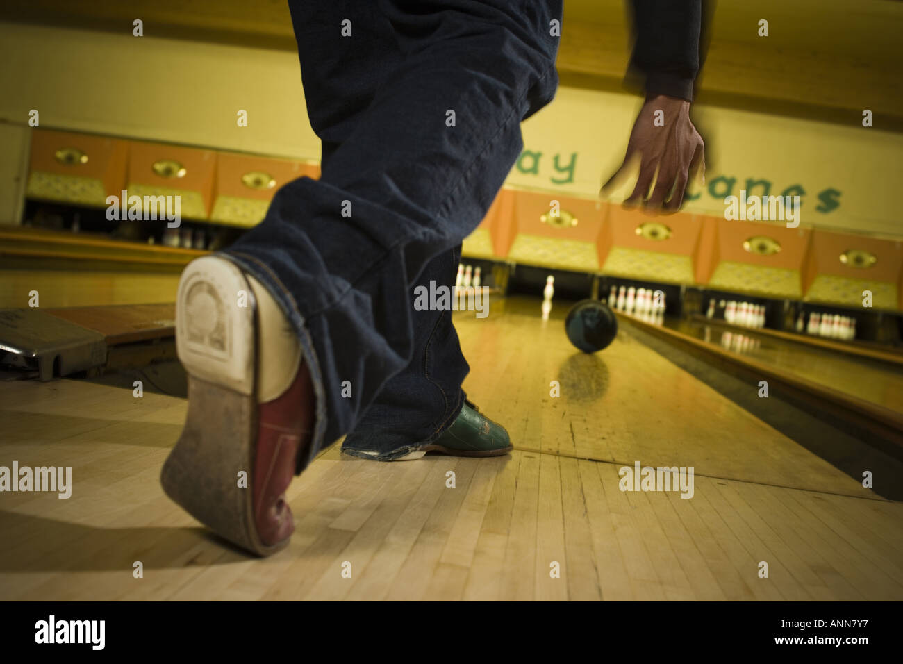 Low section view of a young man bowling at a bowling alley Stock Photo ...