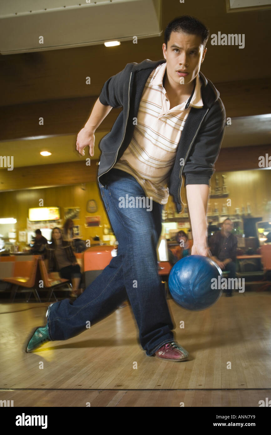 Young man bowling in a bowling alley Stock Photo - Alamy