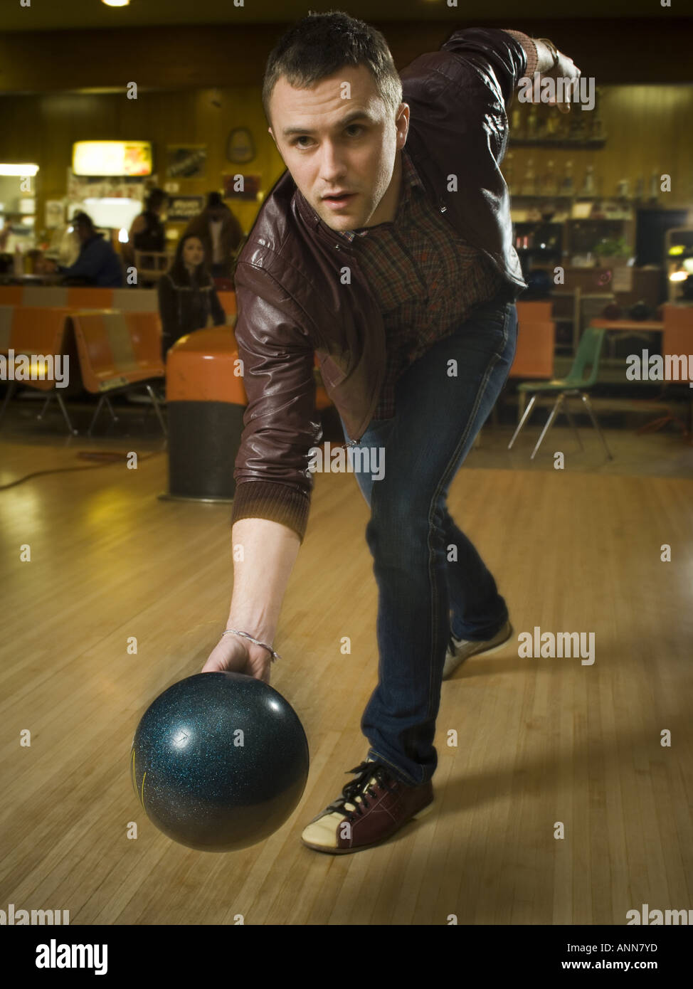 Young man bowling in a bowling alley Stock Photo - Alamy