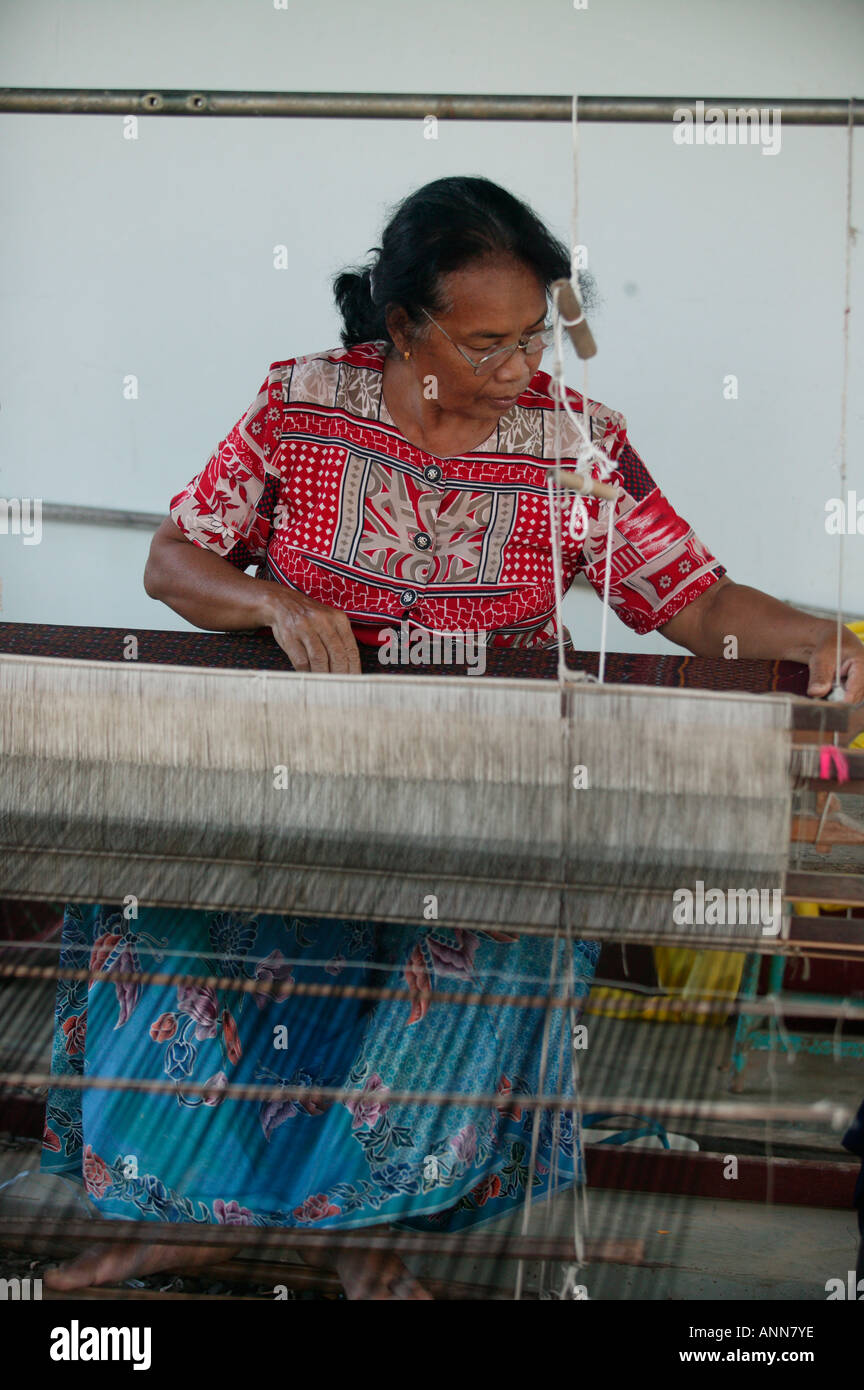 A lady weaving silk on a loom at Ban Khwao Sinarin a silk weaving ...