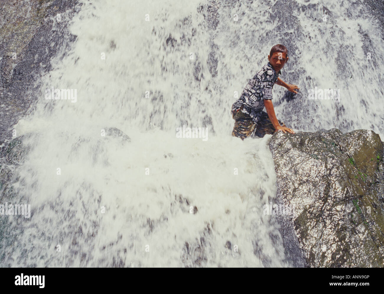 young boy standing in waterfall, Luang Probang Stock Photo - Alamy