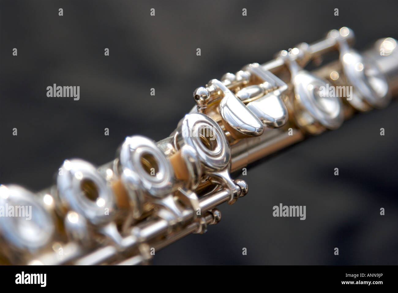A silver flute on a grey background Stock Photo - Alamy