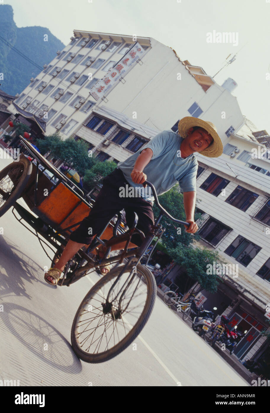 man riding bike with cart, China Stock Photo - Alamy