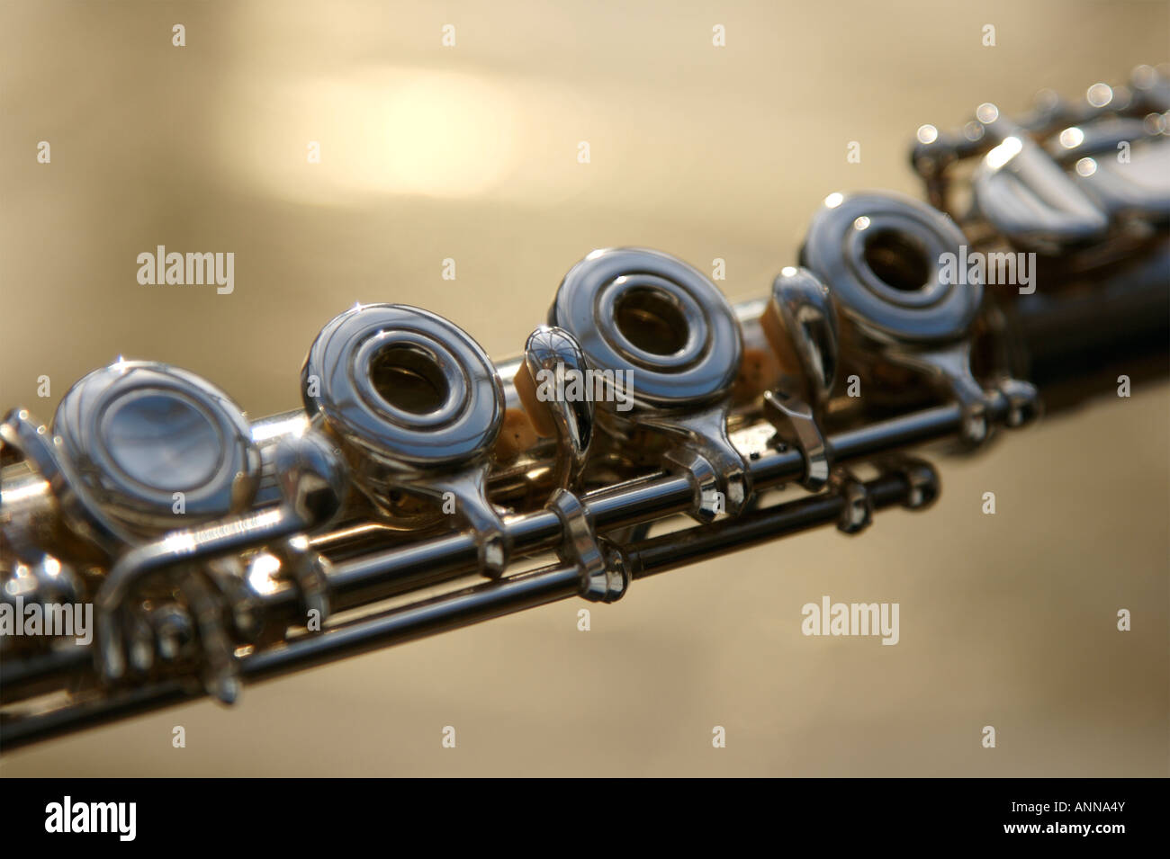 A silver flute on a cream background Stock Photo - Alamy