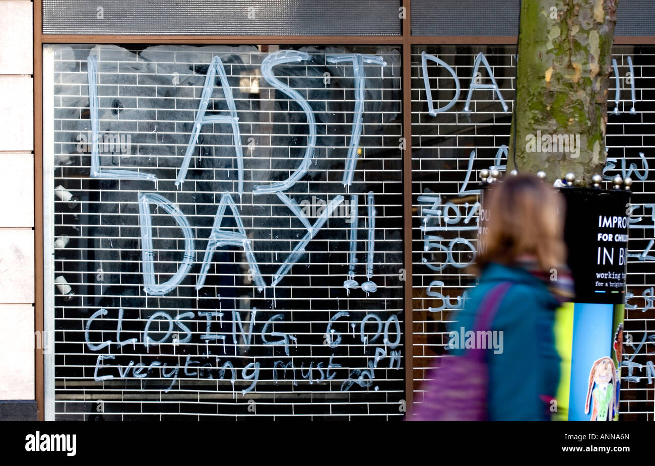 Shoppers walk passed a closing down store in Birmingham UK Stock Photo ...