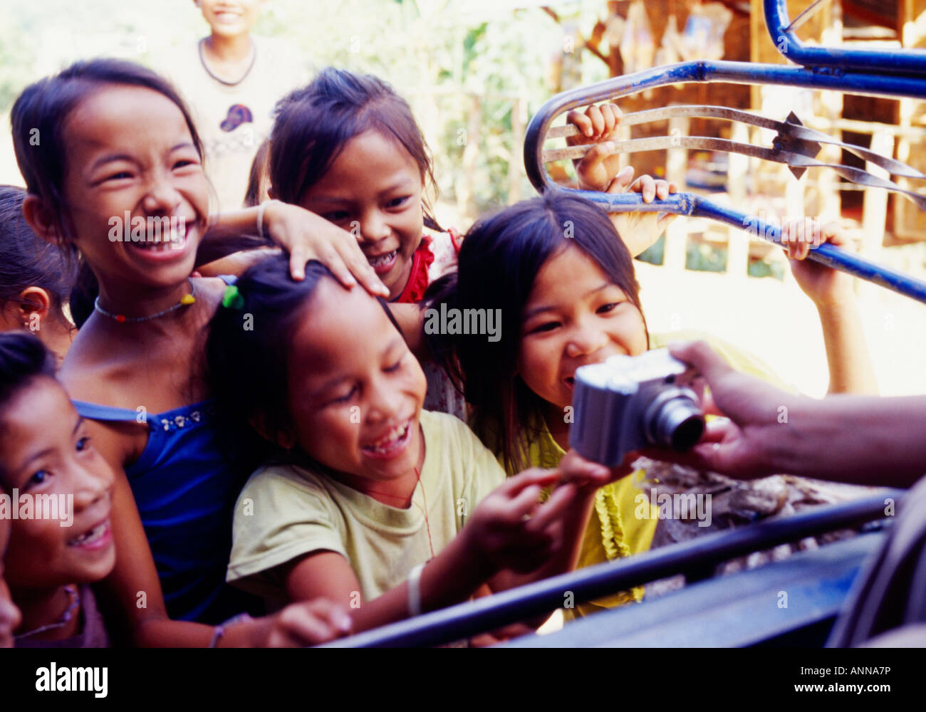 young Asian kids looking at digital camera, Laos Stock Photo - Alamy