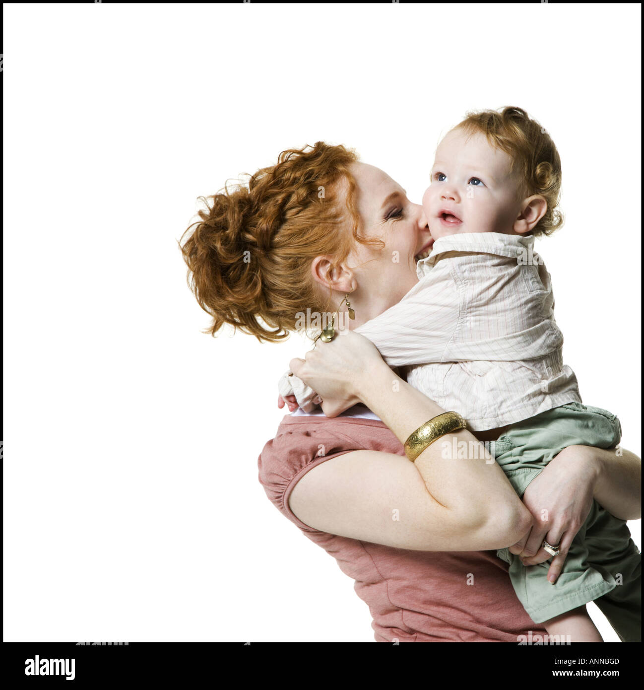 Close up of a young woman carrying her baby girl Stock Photo - Alamy