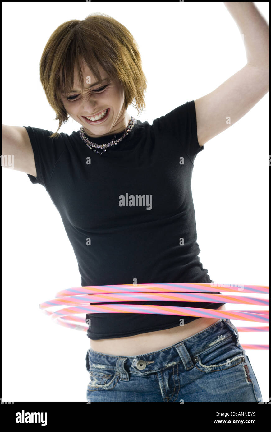 Close up of a teenage girl spinning hula hoops around her waist Stock ...