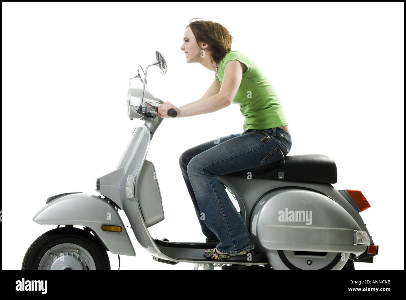 Profile of a teenage girl riding a scooter Stock Photo - Alamy