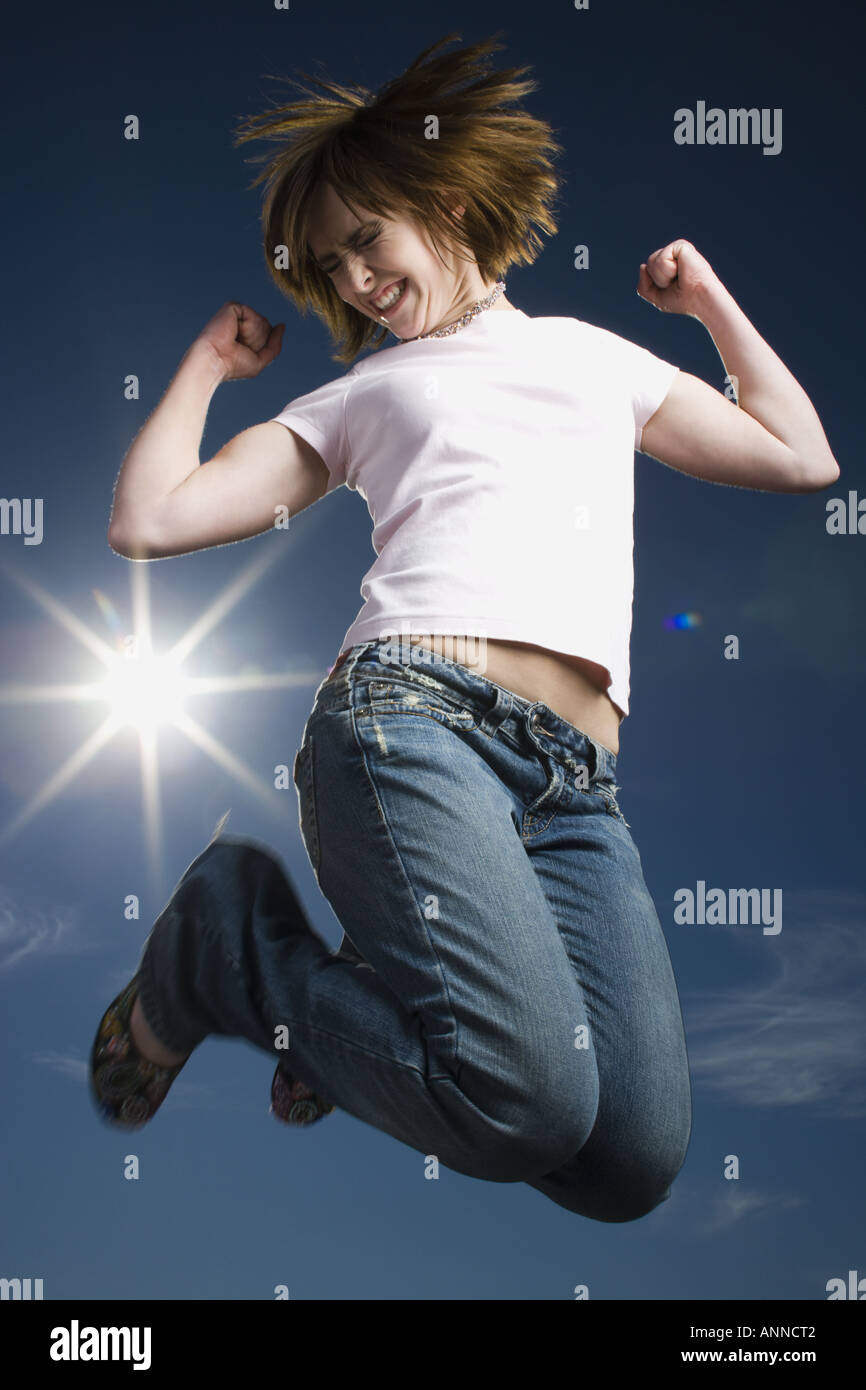 Low angle view of a teenage girl jumping Stock Photo - Alamy