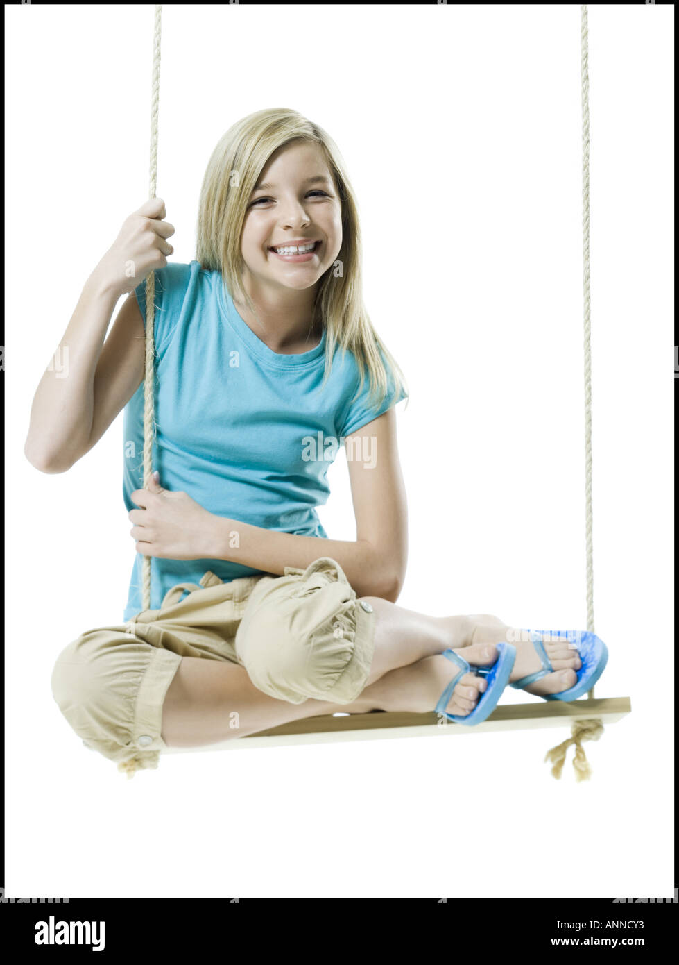 Portrait of a girl sitting on a rope swing Stock Photo - Alamy