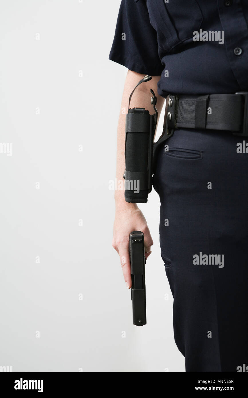 Police woman holding a loaded pistol ready to fire Stock Photo - Alamy