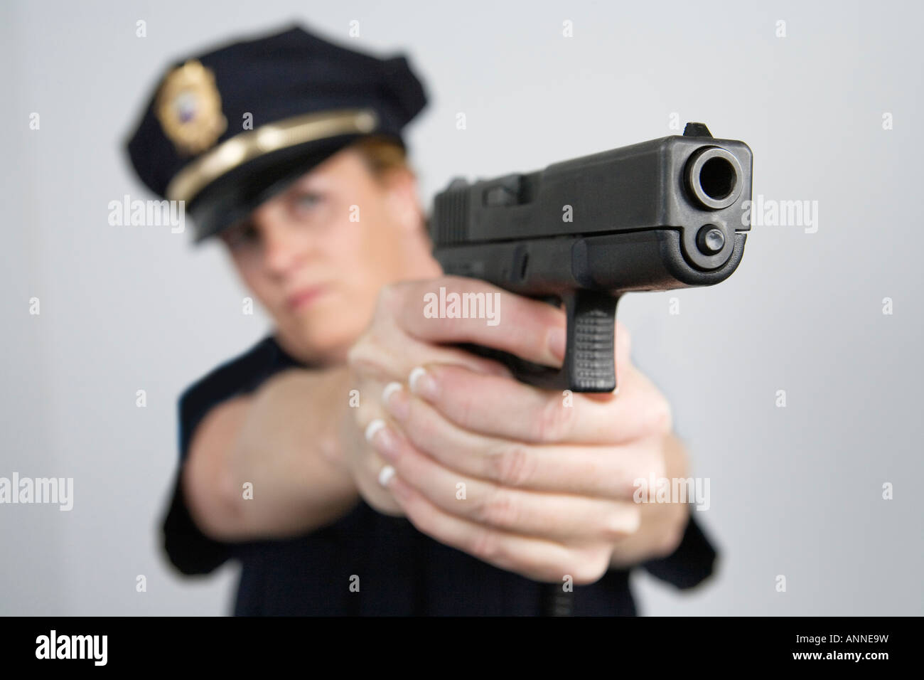 View of a police woman aiming with pistol Stock Photo - Alamy